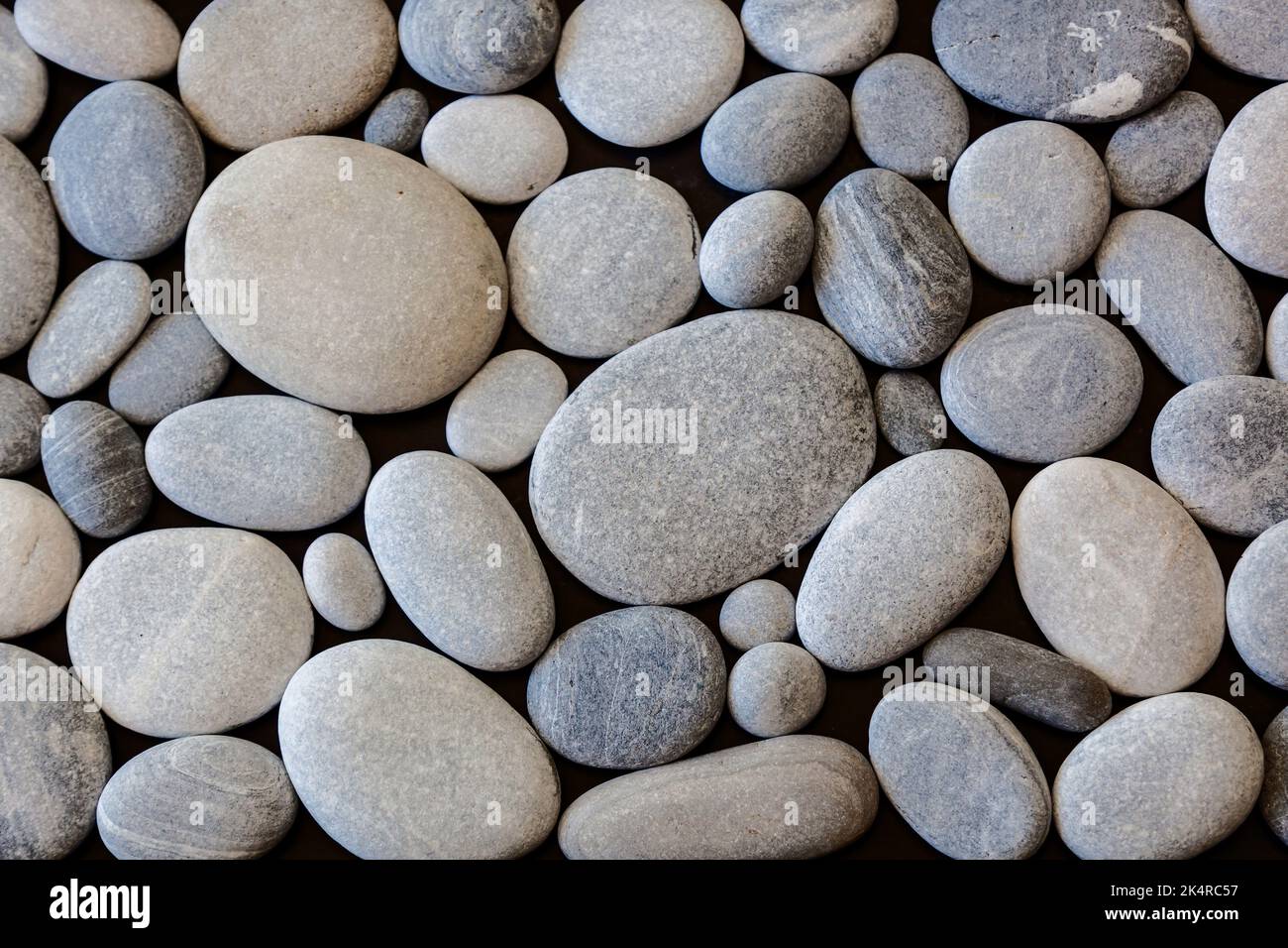 background of round stones of different sizes of light pebbles Stock ...