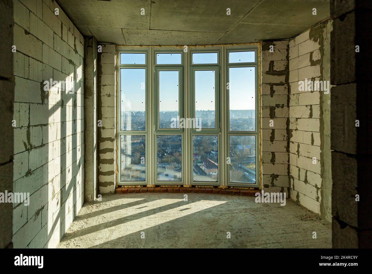 Empty draft rooms in a high-rise building under construction. Shadows ...