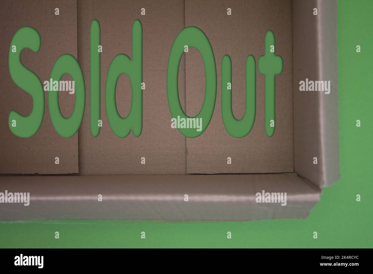 Sold Out word with cardboard box. Brown folded card box Stock Photo - Alamy