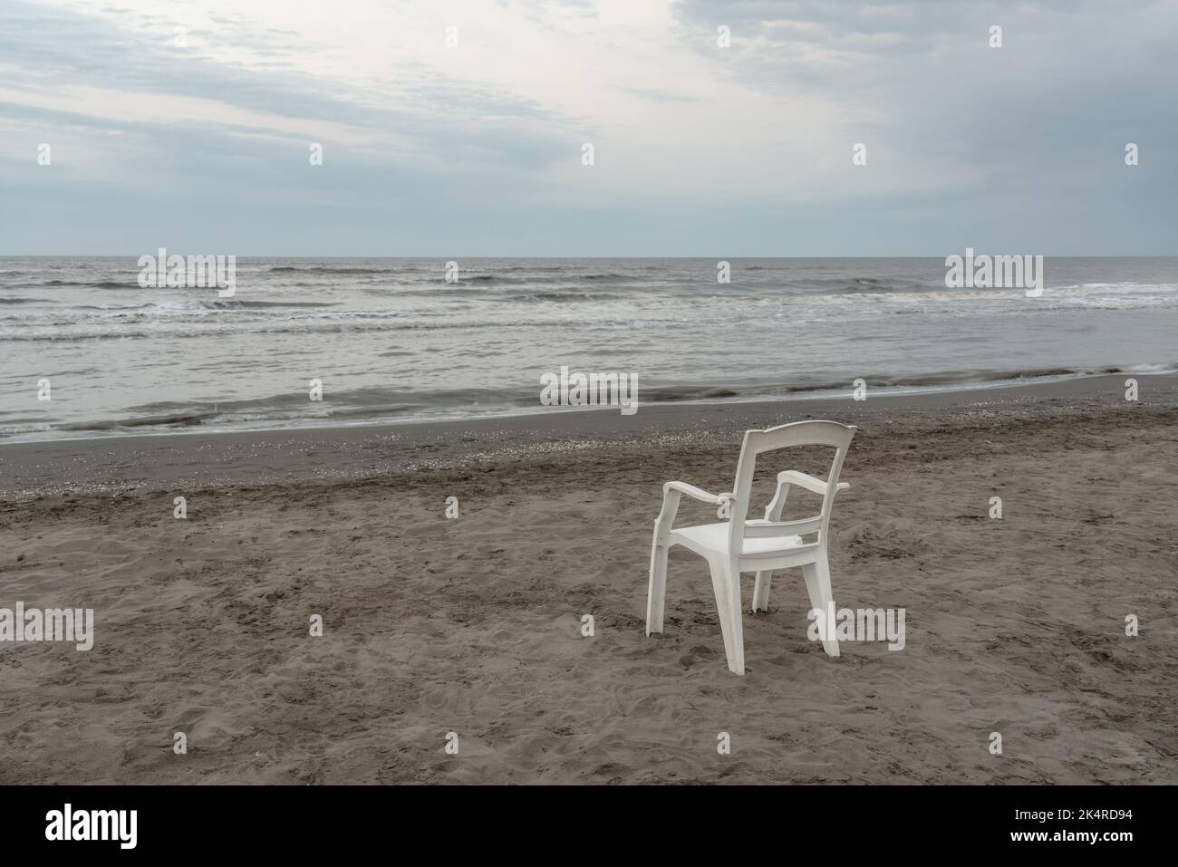 Lonely chair on sea beach Stock Photo - Alamy