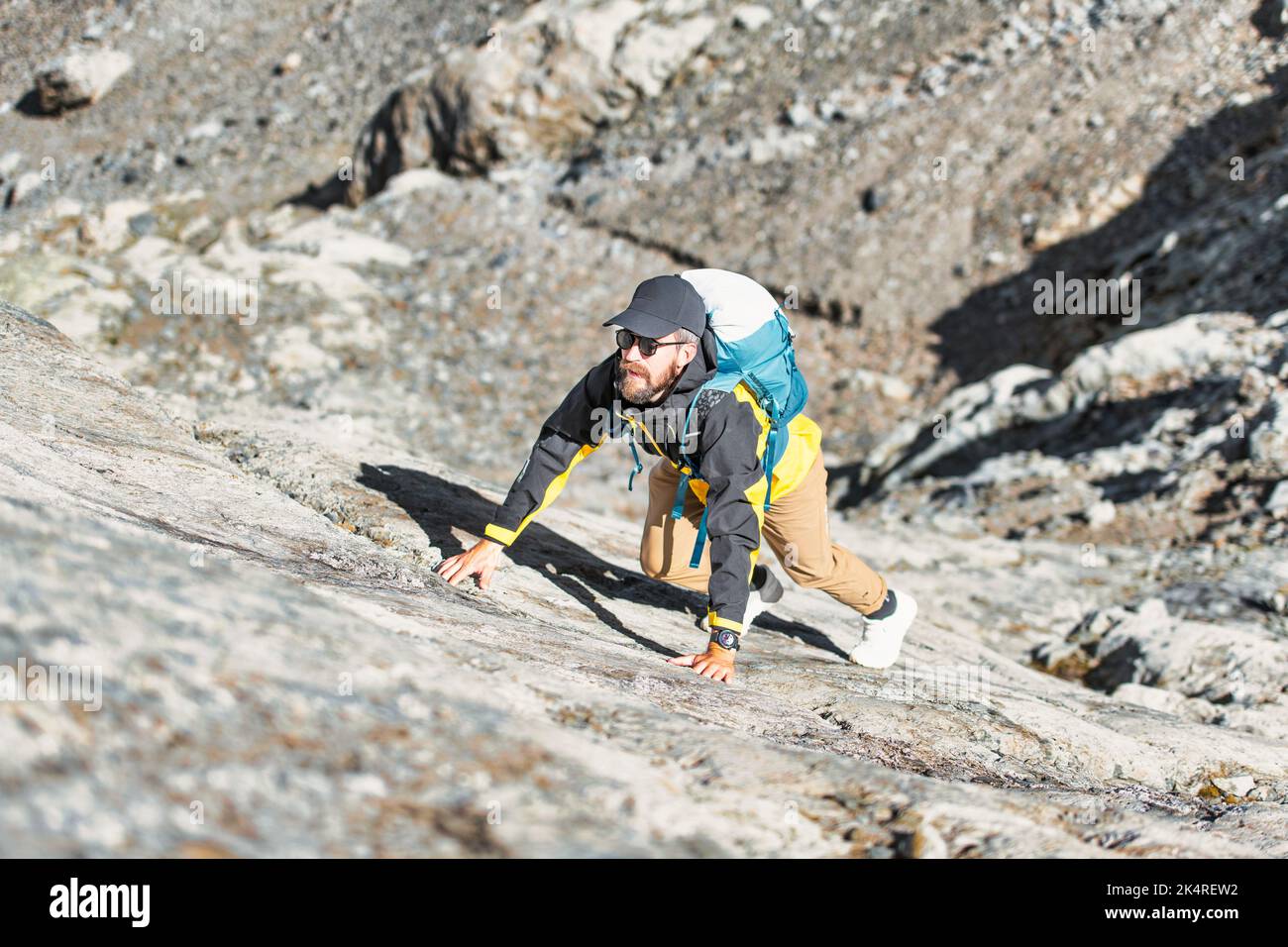 Young man climbs rock in mountain alone Stock Photo - Alamy