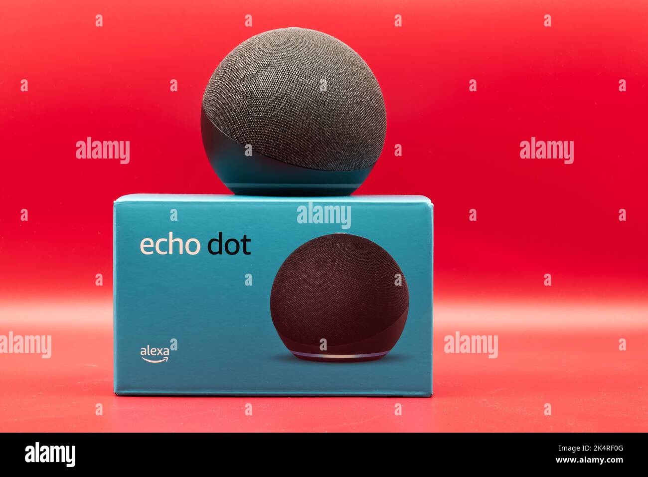 Amazon Echo Dot. Alexa, virtual assistant AI. Red background Stock ...