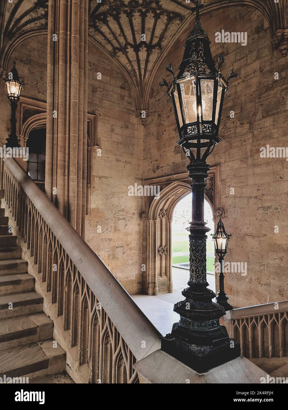 A vertical shot of a lamp post on the rail of a staircase with vintage ...