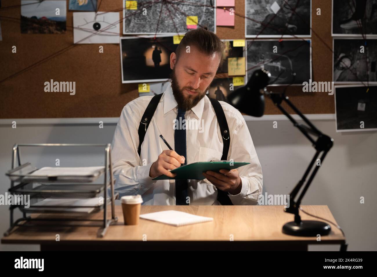 Detective working in the office at his desk, investigator at work Stock ...