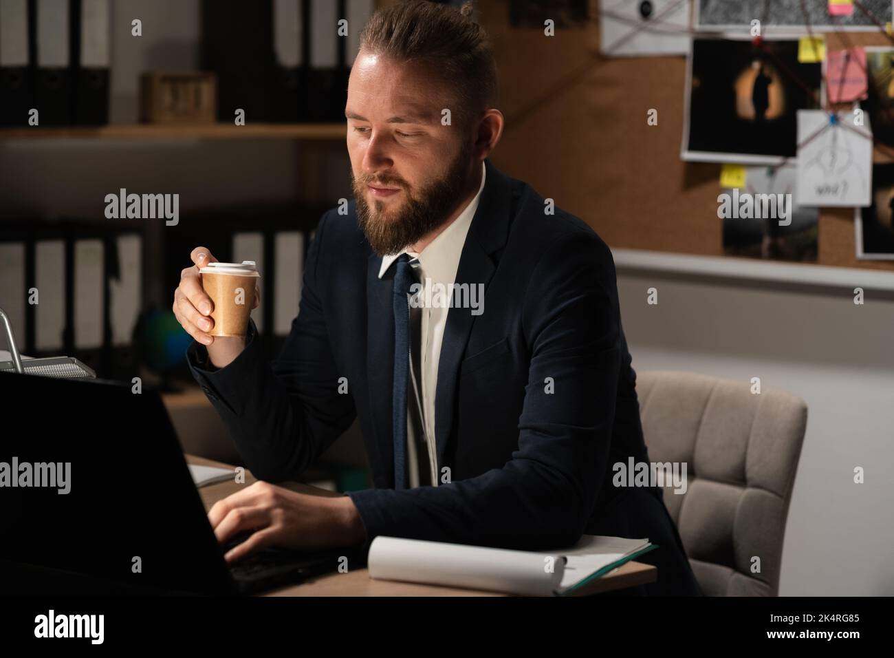 Detective working in the office using a computer, process of analyzing ...