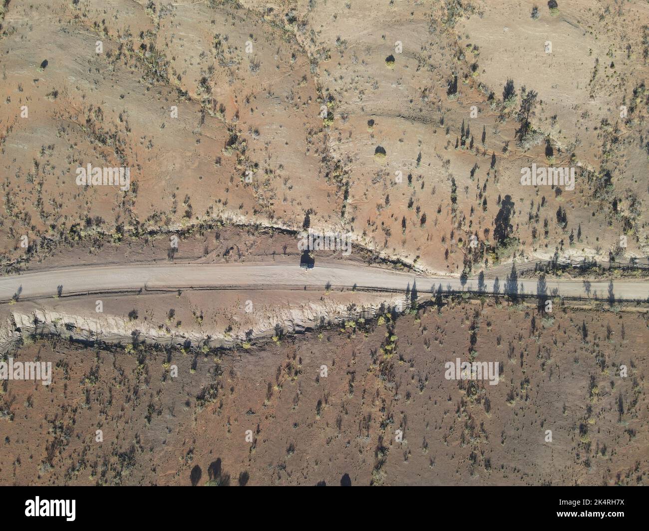 An aerial view of road surrounded by sandy fields Stock Photo - Alamy