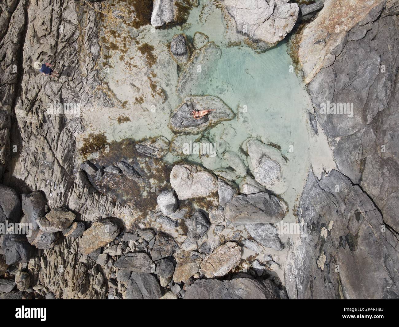 An aerial view of rock formations with human sitting on rock Stock ...