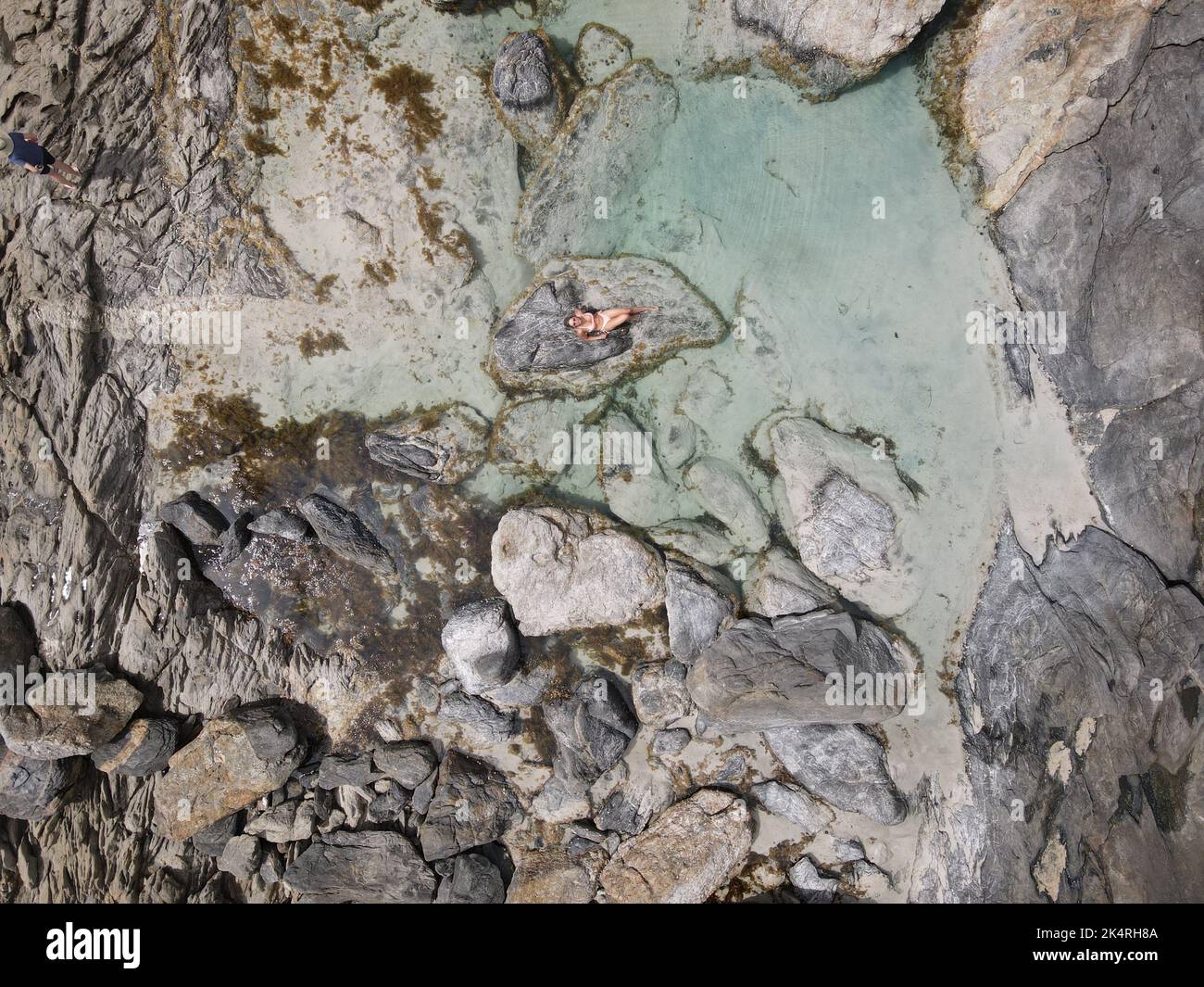 An aerial view of rock formations with human sitting on rock Stock ...