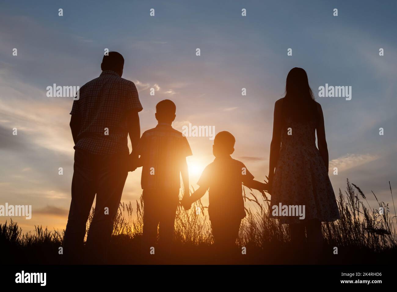 Family standing among fields spends holidays in countryside Stock Photo ...