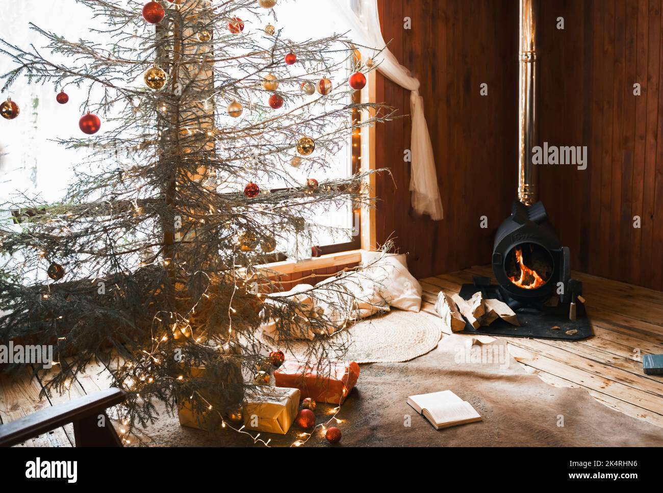 Interior of cozy wooden country house in winter forest.Home stoking ...