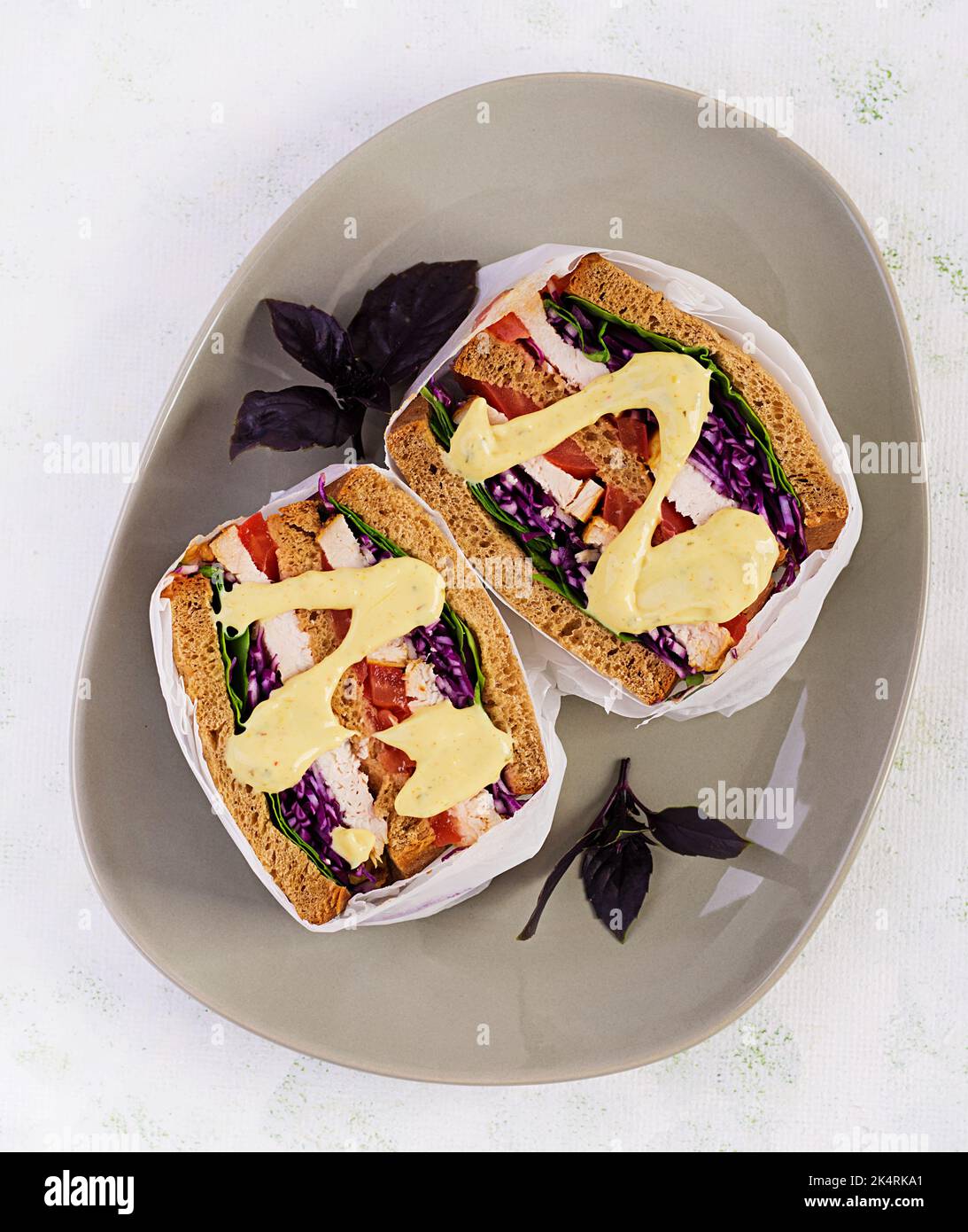 Sandwich with chicken fillet, red cabbage and sauce, wrapped in paper ...