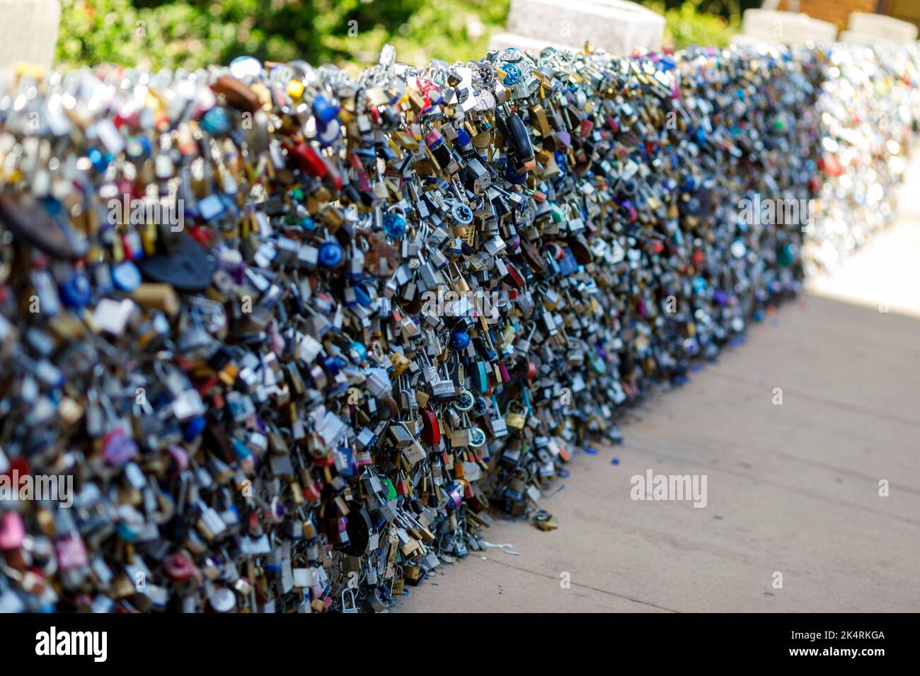 Old and new padlocks with names and dates written on them lock on a ...