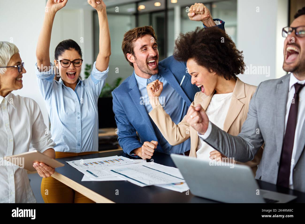 Group of successful multiethnic business people celebrating a good job ...