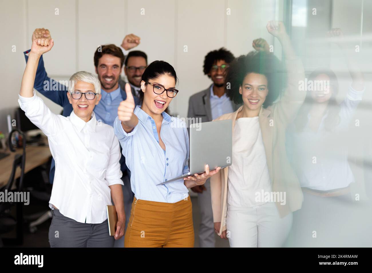 Group of successful multiethnic business people celebrating a good job ...
