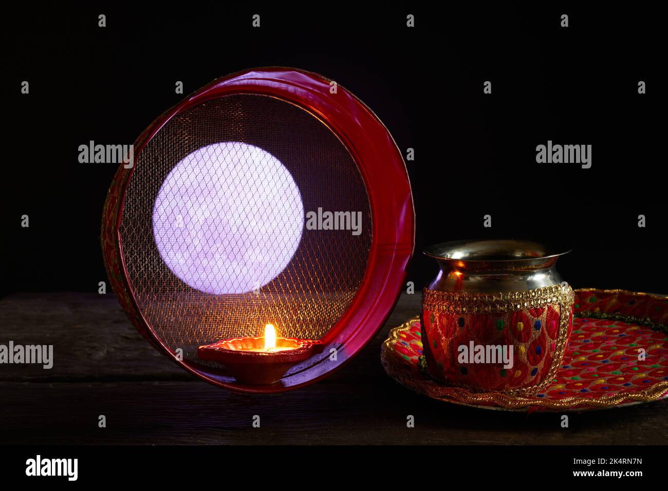 Woman celebrating Karva Chauth at night. Karva Chauth is a one-day ...