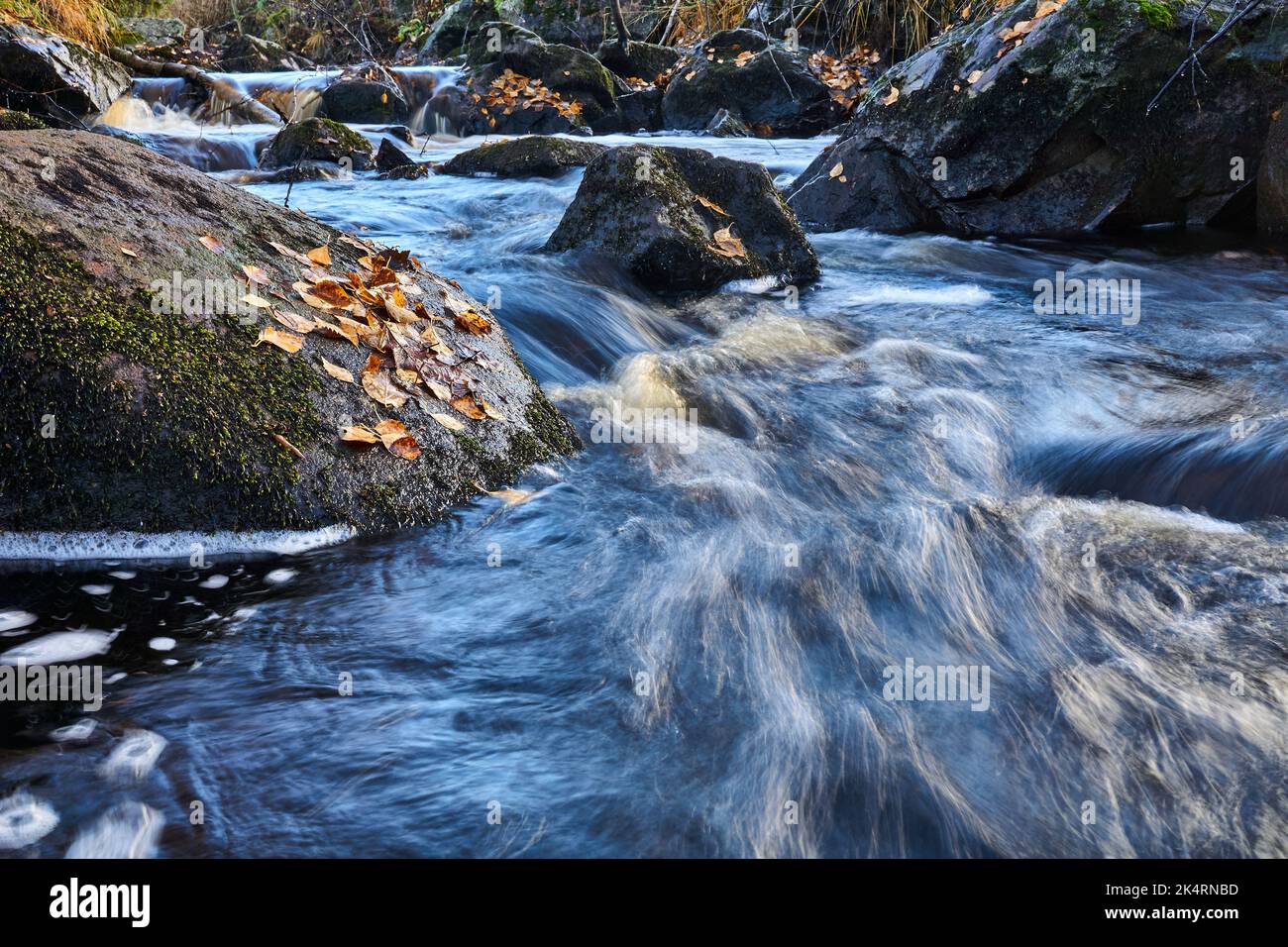 A low exposure of water flowing down the rocks in autumn Stock Photo ...
