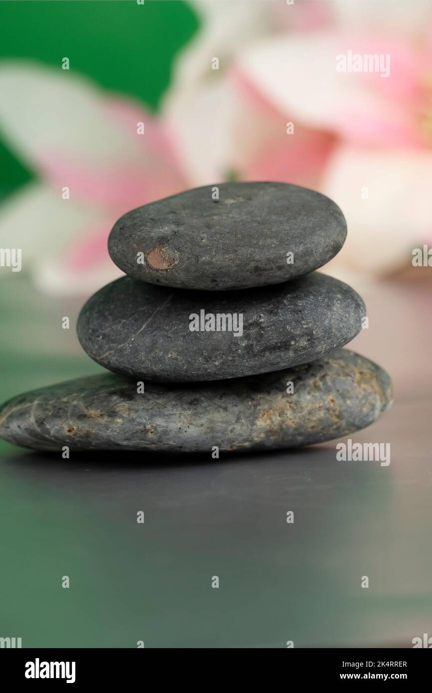A vertical shot of a stack of stones with beautiful orchards in the ...