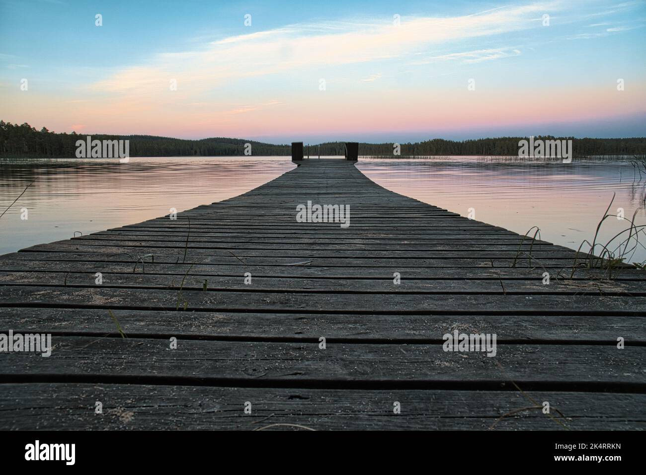Wooden jetty reaching into a swedish lake at blue hour. Nature shot ...