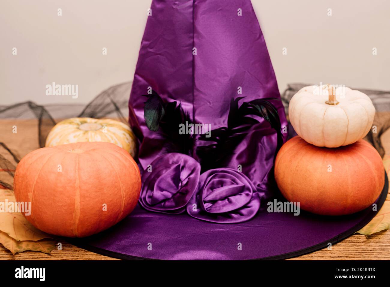 Halloween Purple Witch Hat with Pumpkins Party Stock Photo - Alamy