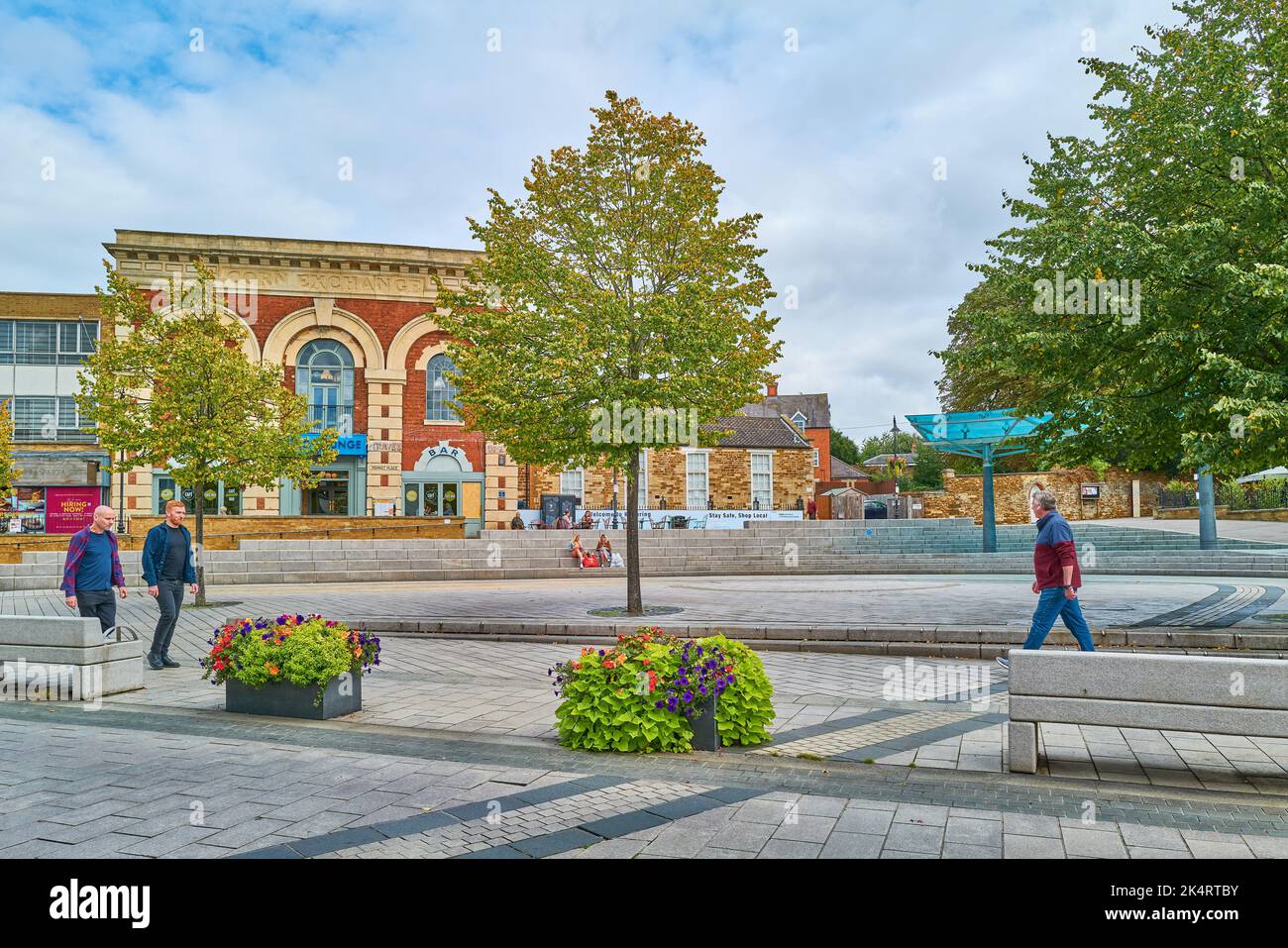 People in Market Square, Kettering, England, on an early autumn day ...