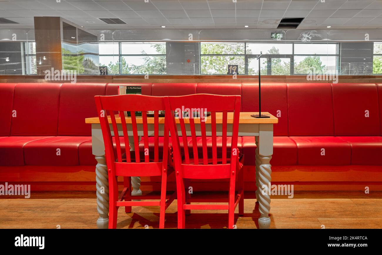 Brightly coloured red seating in the café at a Morrisons supermarket ...