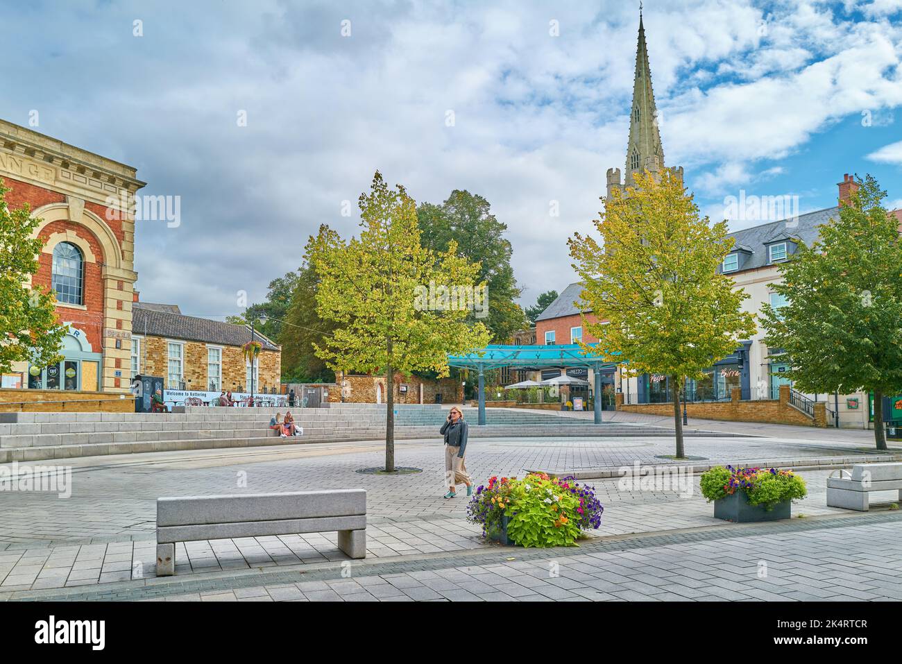 People in Market Square, Kettering, England, on an early autumn day ...