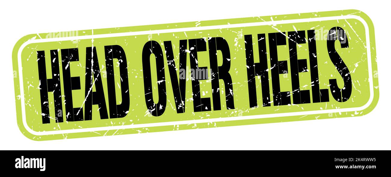 HEAD OVER HEELS text written on green-black grungy stamp sign Stock ...