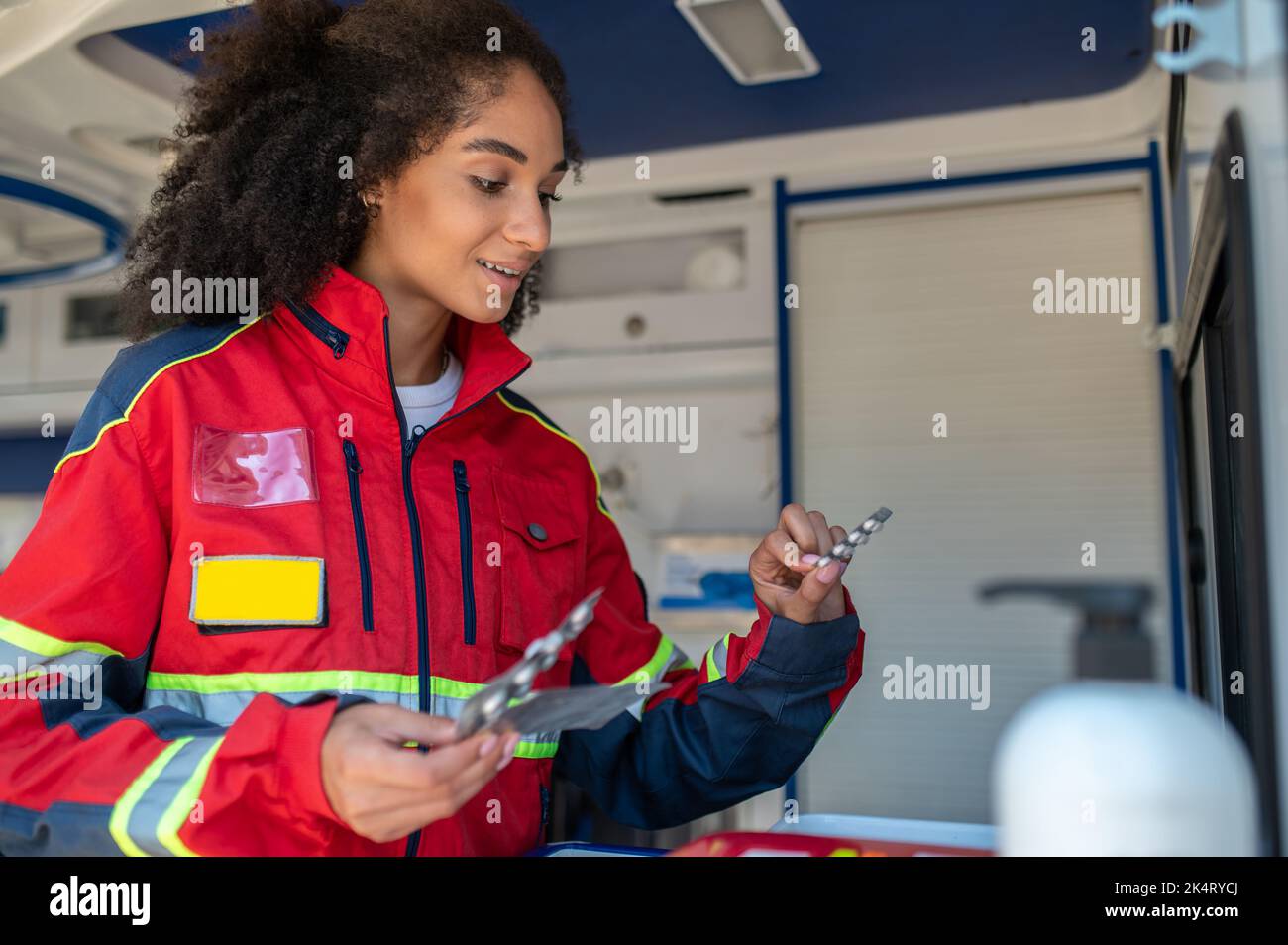 Paramedical professional monitoring pharmaceuticals in the ambulance ...