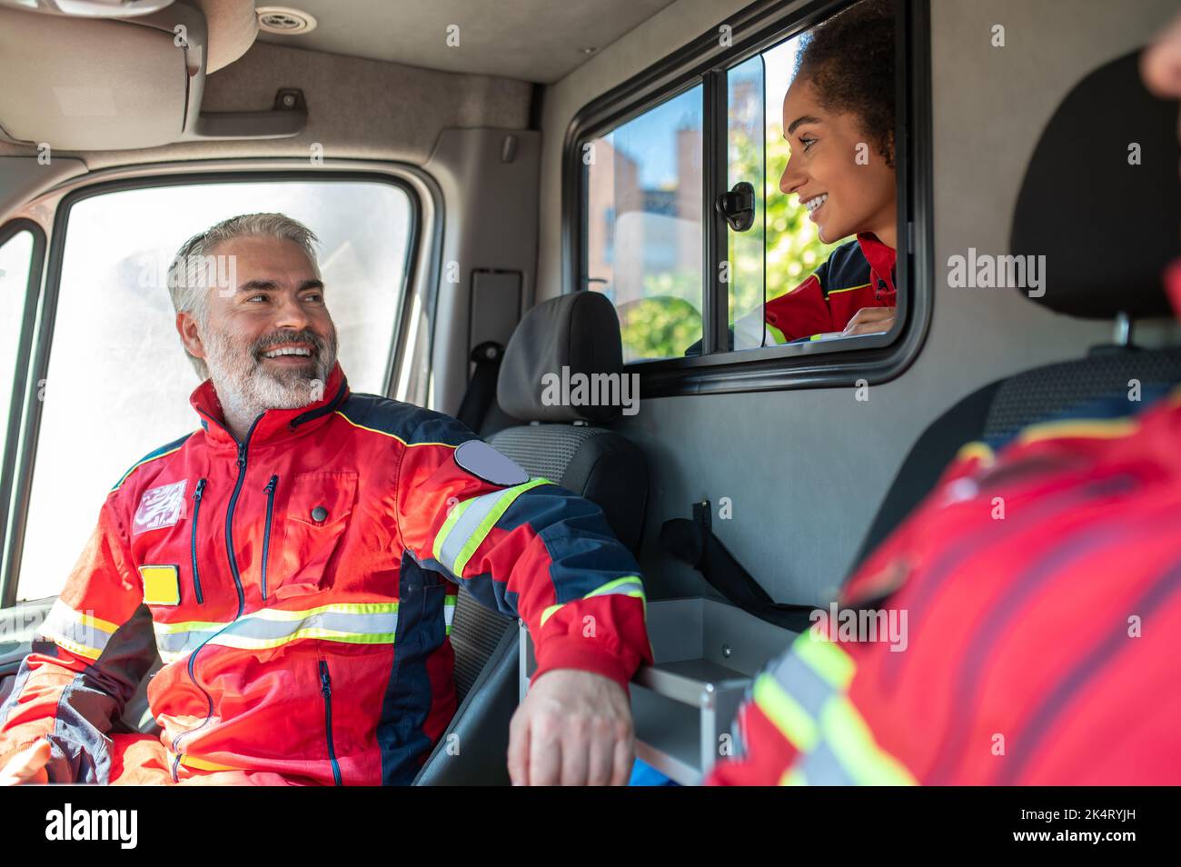 Team of paramedics talking in the ambulance car Stock Photo - Alamy