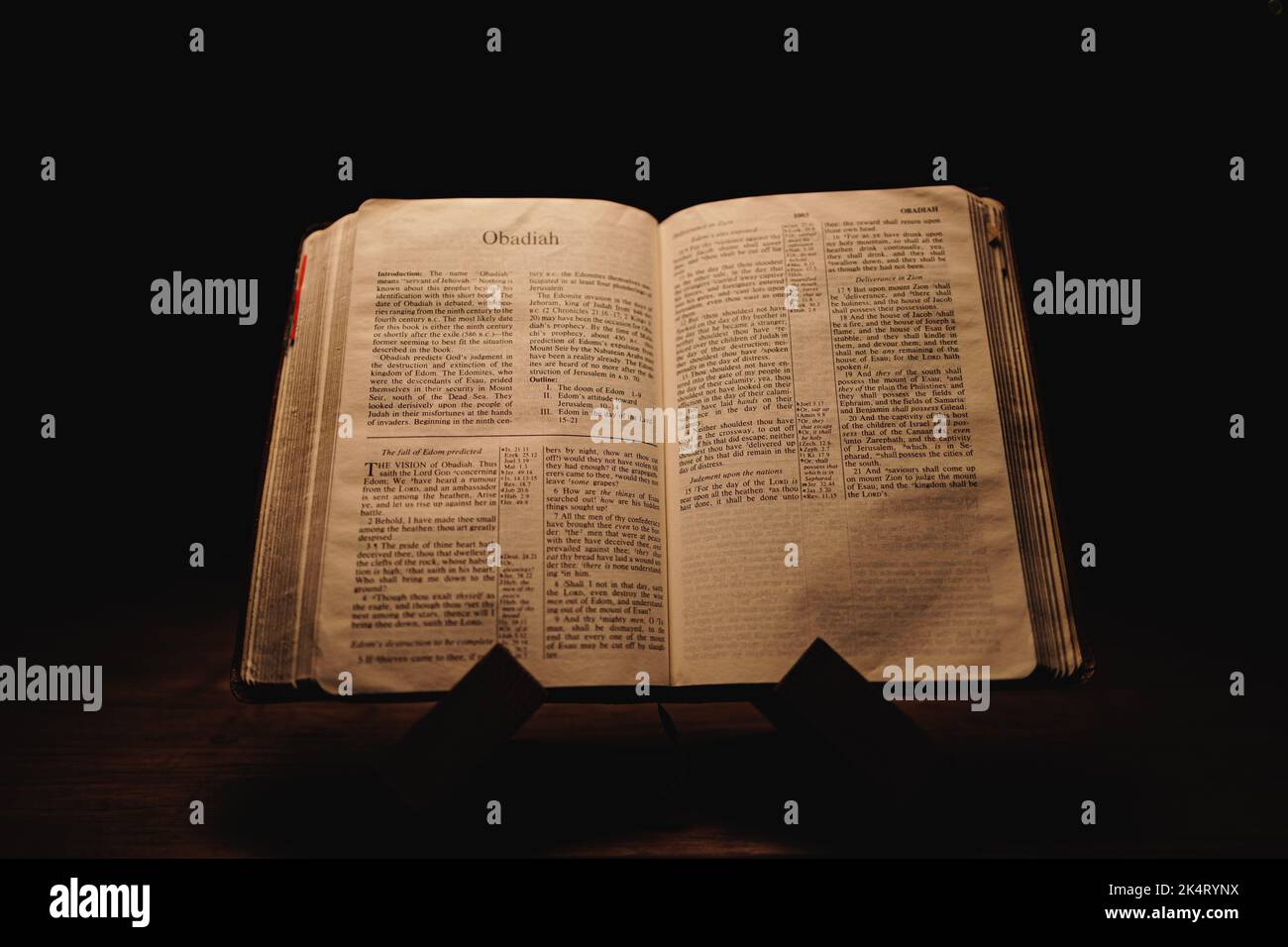 A closeup shot of a historic old Bible open on the Obadiah pages on ...