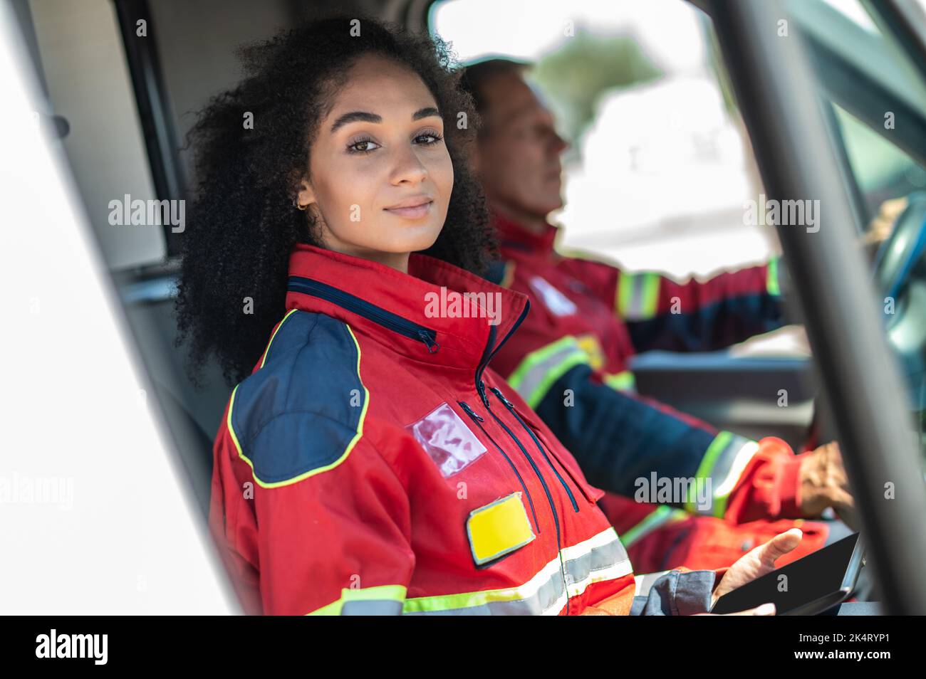 Paramedical personnel seated in the medical emergency vehicle Stock ...
