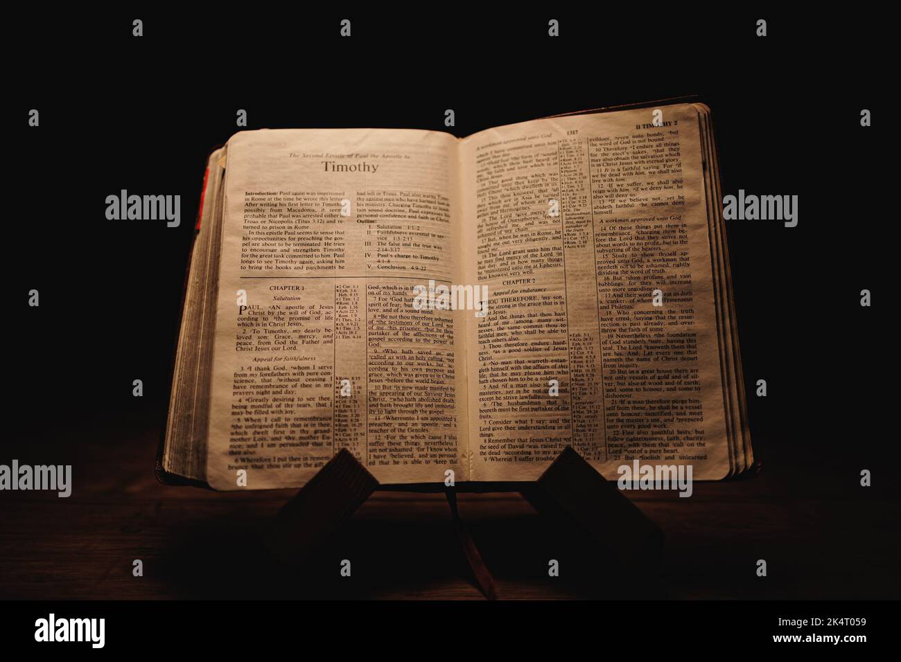 A closeup shot of a historic old Bible open on the Timothy pages on ...