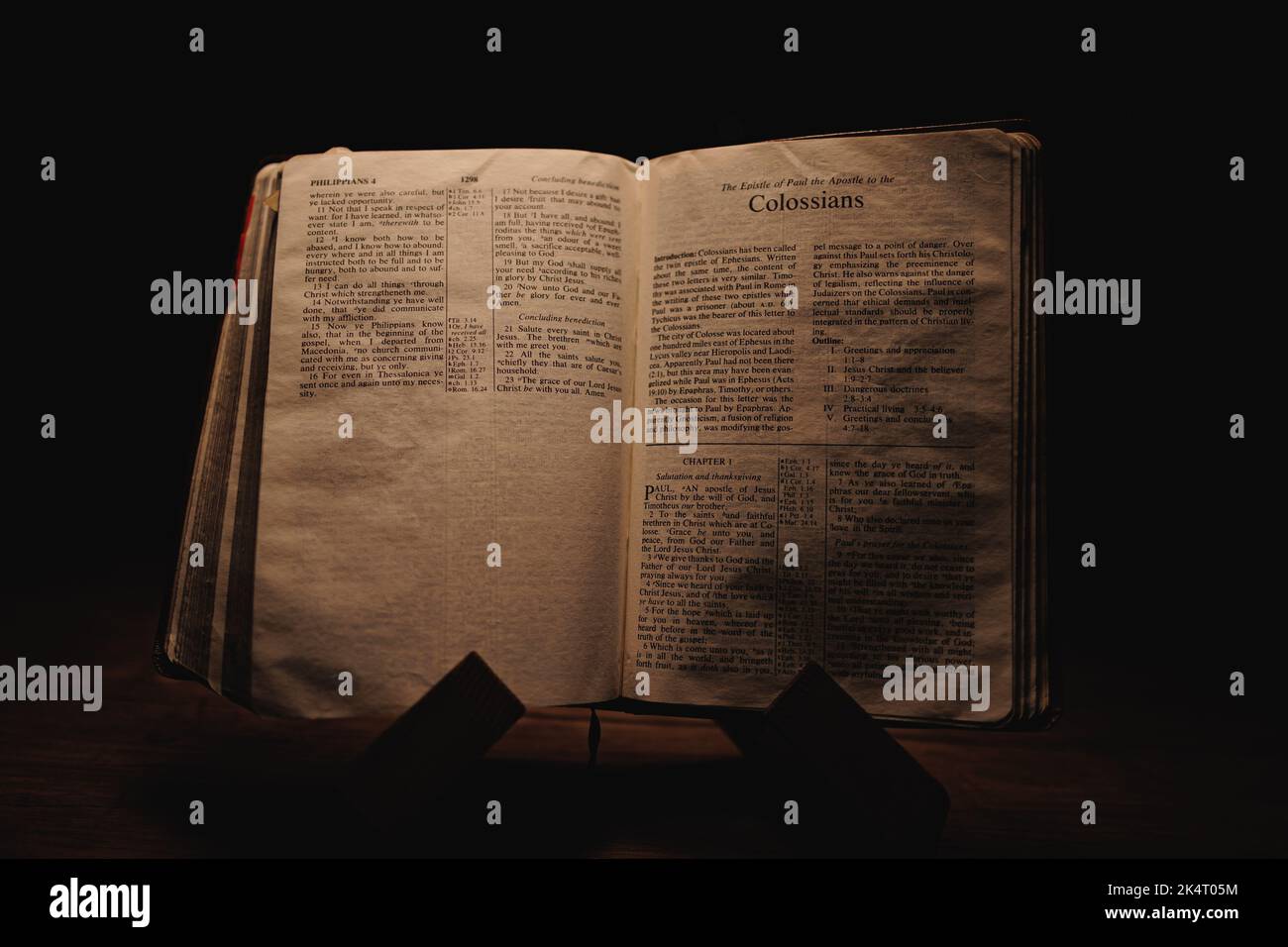 A closeup shot of a historic old Bible open on the Colossians pages on ...