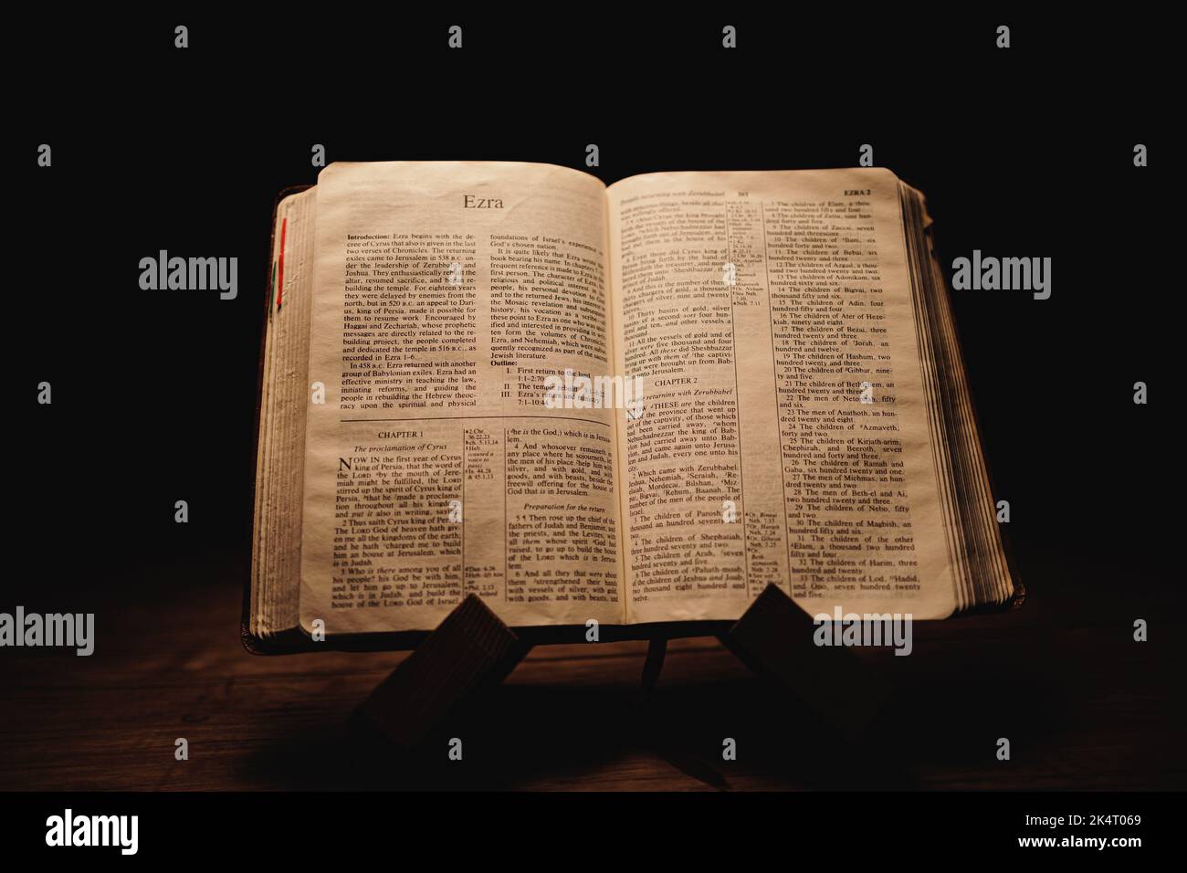 A closeup shot of a historic old Bible open on the Ezra pages on ...