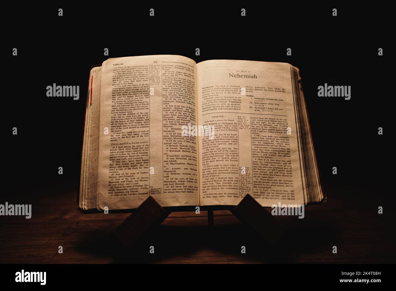 A closeup shot of a historic old Bible open on the Nehemiah pages on ...