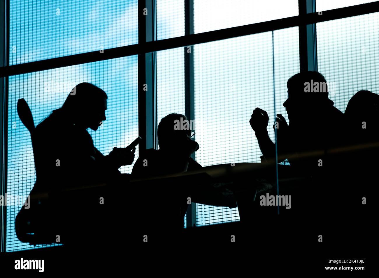 Boss speaking to employees at night Stock Photo - Alamy