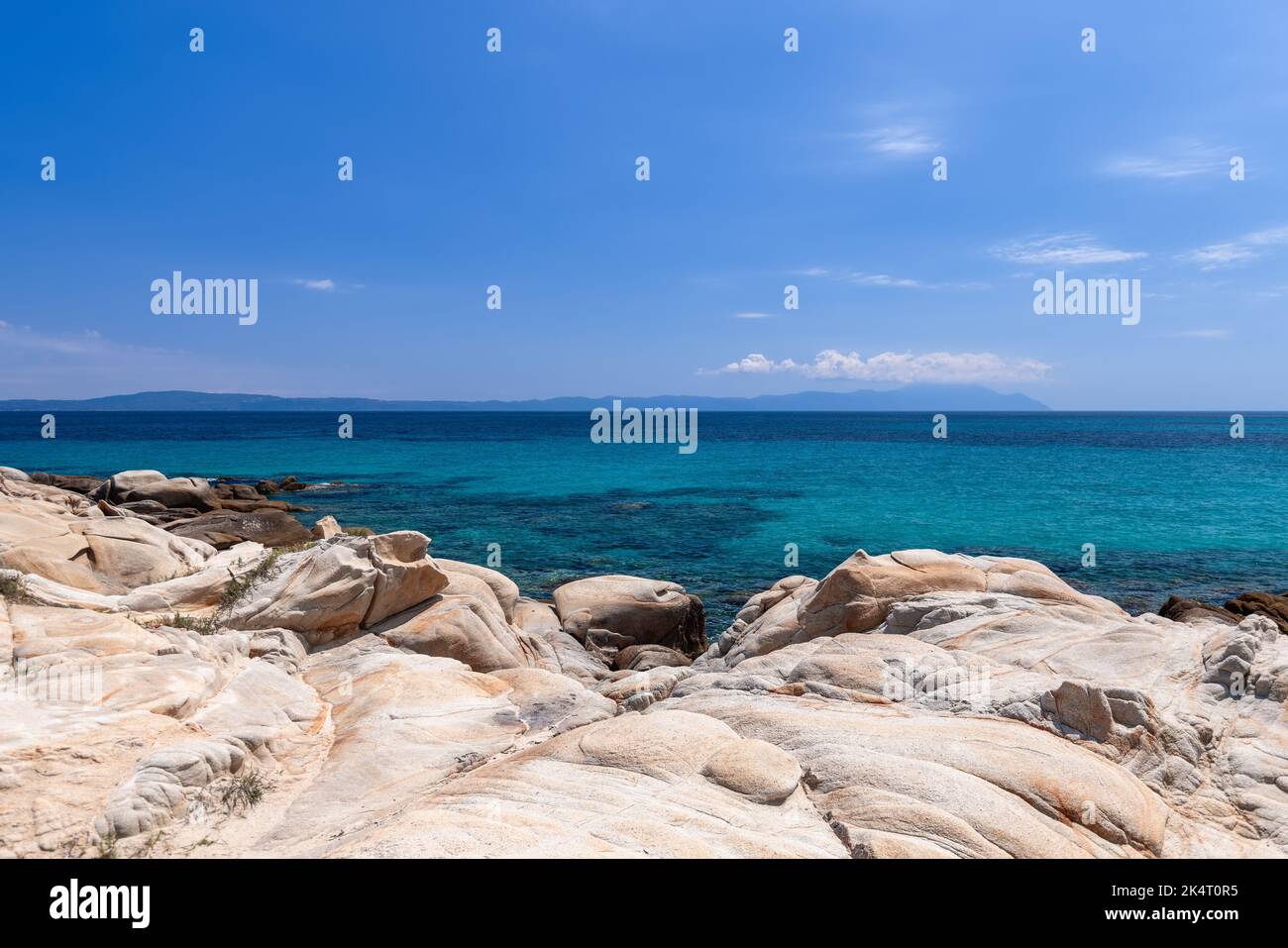 Unusual rounded rocks on costal line of Karidi beach, shallow warm ...