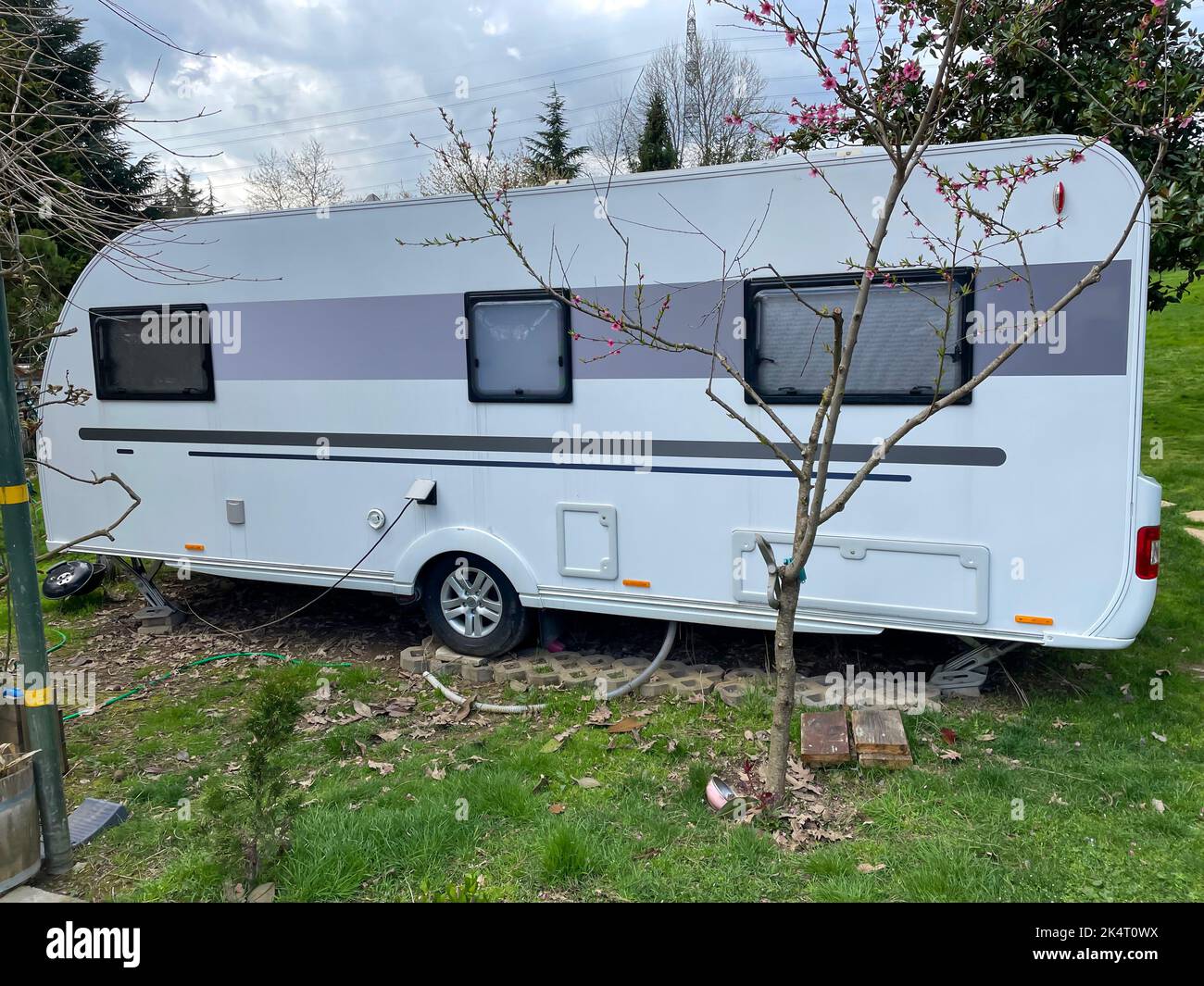 A travel trailer at a caravan campsite. Caravan camping concept Stock ...