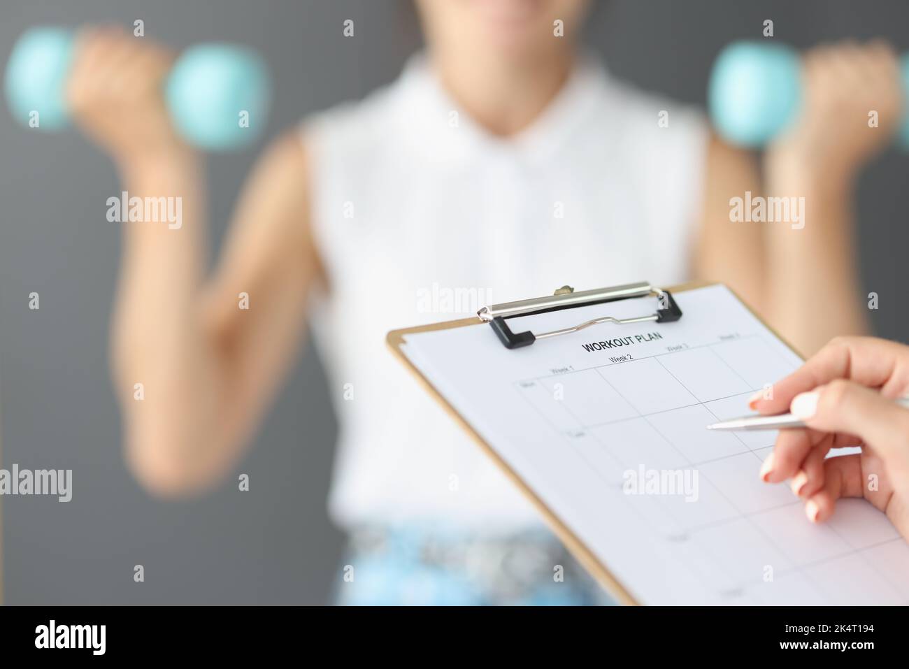 Female hands are writing down a workout plan, motivation Stock Photo ...