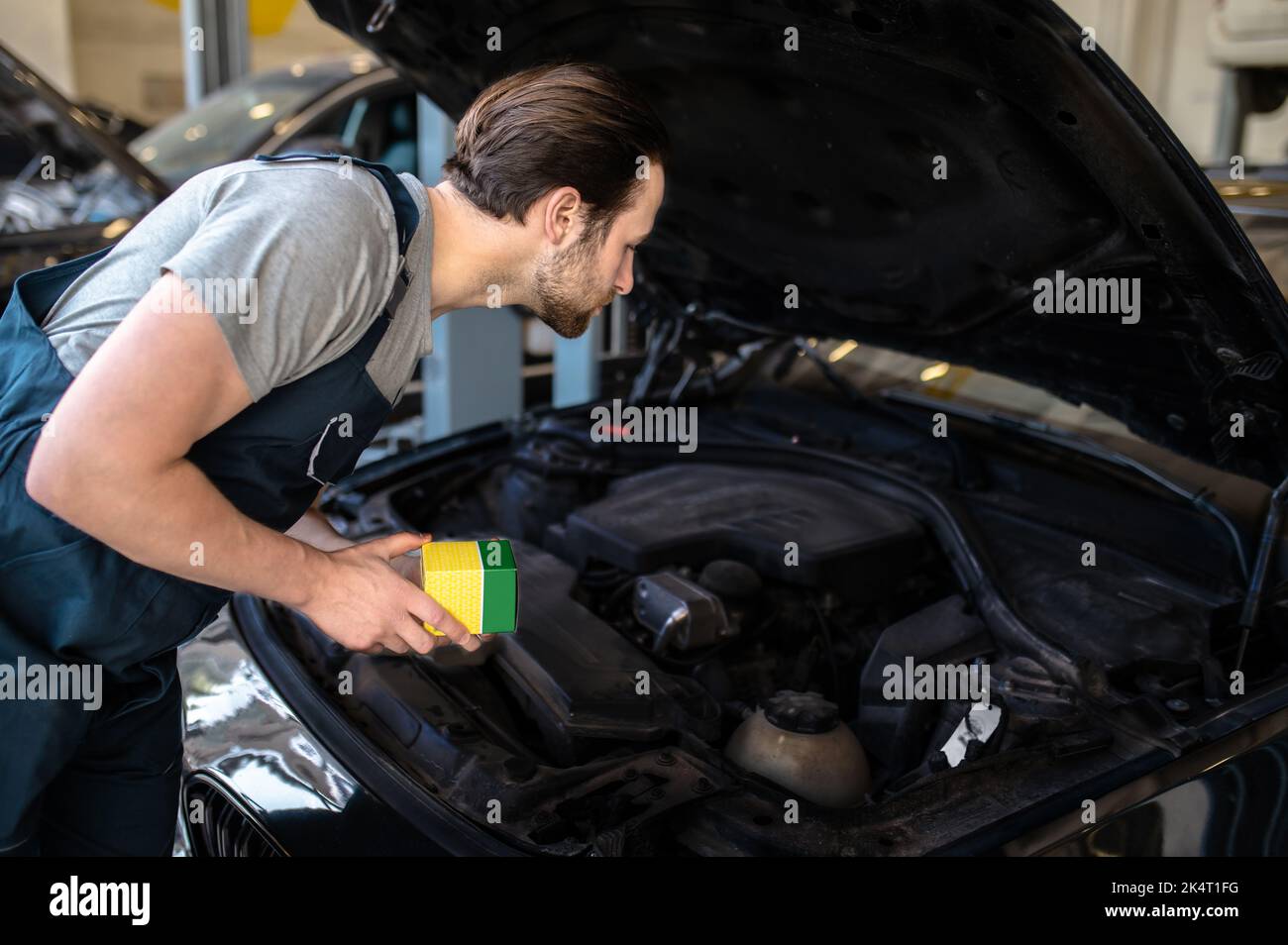 Car repair worker working at the service station Stock Photo - Alamy