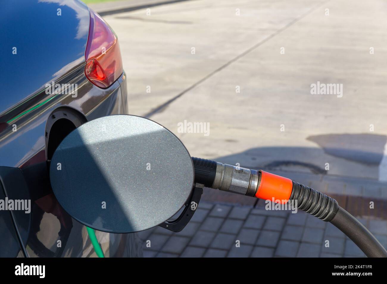 Fuel nozzle to refill fuel in car at gas station. Red fuel dispenser on ...