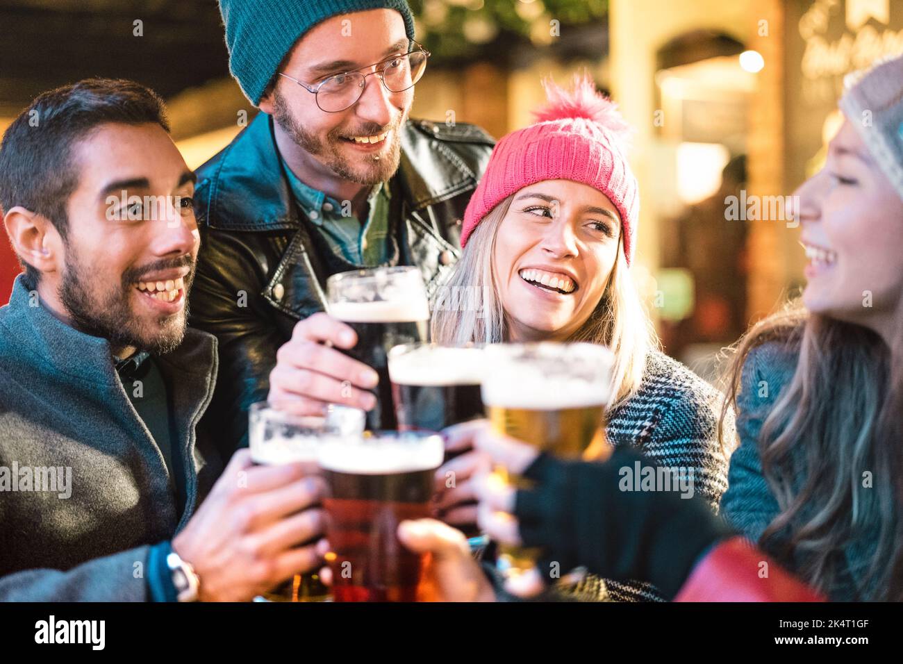Friends drinking beer at brewery bar outdoor on winter time ...