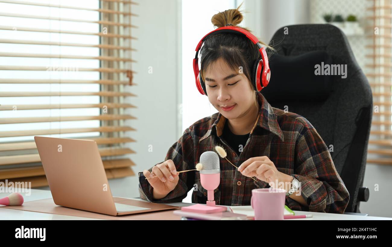 Asian woman in headphone making ASMR sounds in home studio. Triggers ...