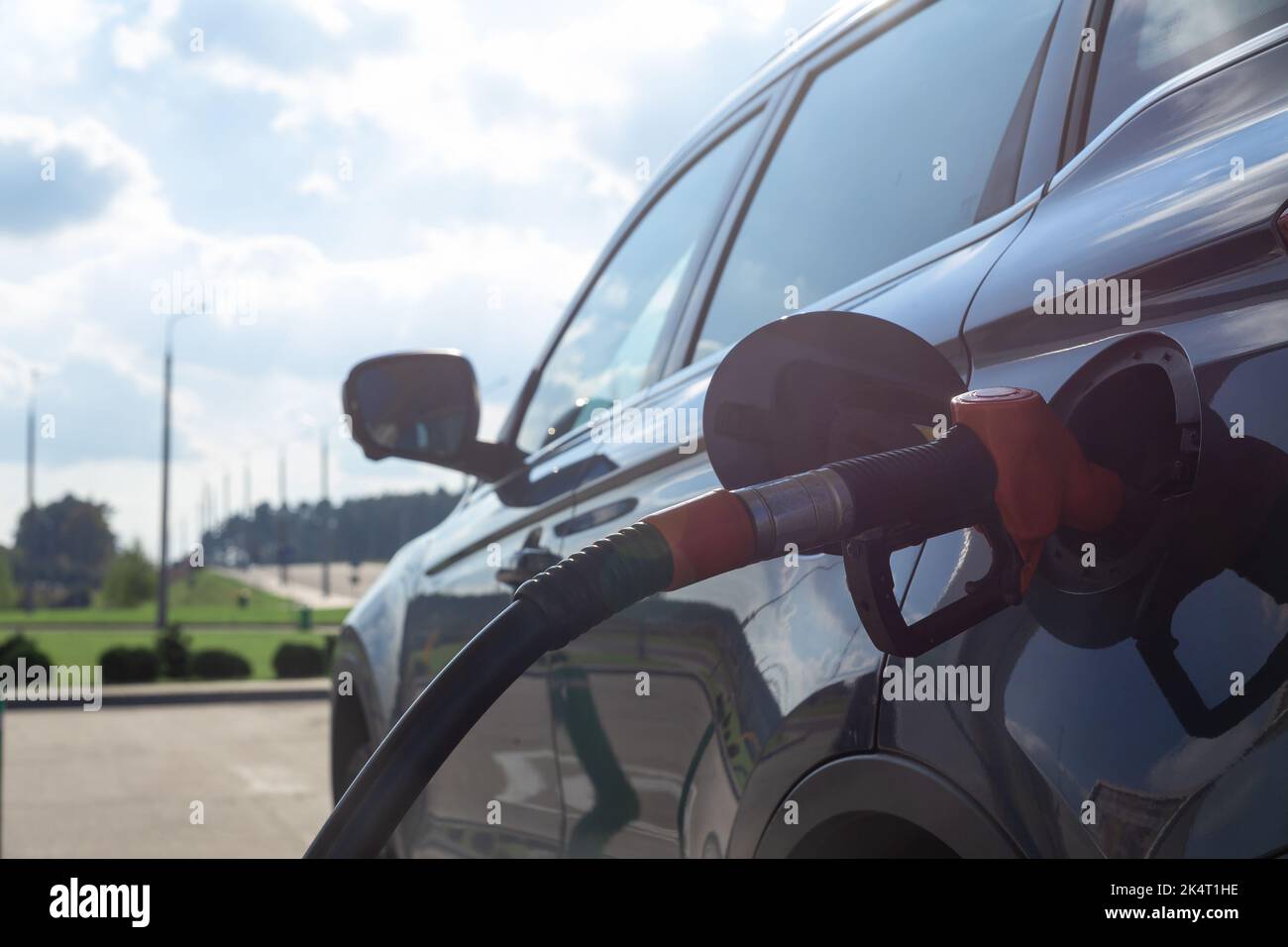 Fuel nozzle to refill fuel in car at gas station. Red fuel dispenser on ...