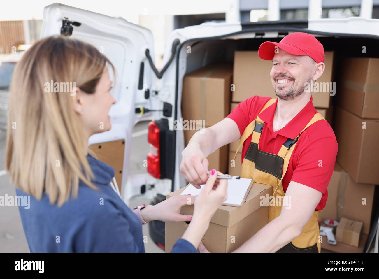 Woman courier delivering carton hi-res stock photography and images - Alamy
