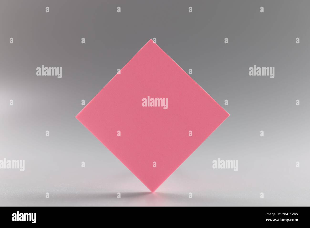 Pink blank paper rhombus on gray background, notepad Stock Photo - Alamy