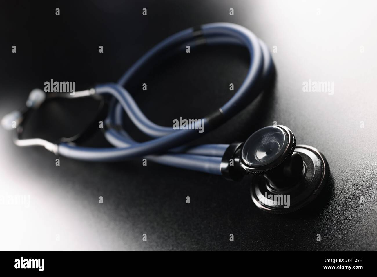 Black stethoscope on a dark matte background Stock Photo - Alamy
