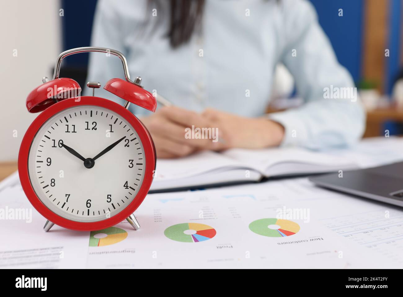 Woman checking clock office hi-res stock photography and images - Alamy