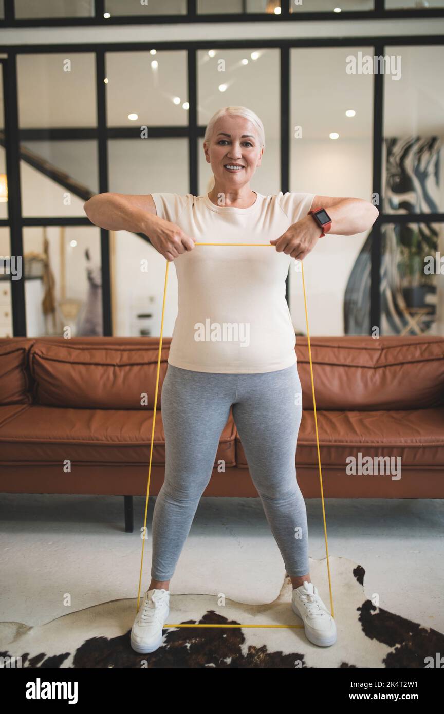 Pleased lady performing an upper body exercise Stock Photo - Alamy