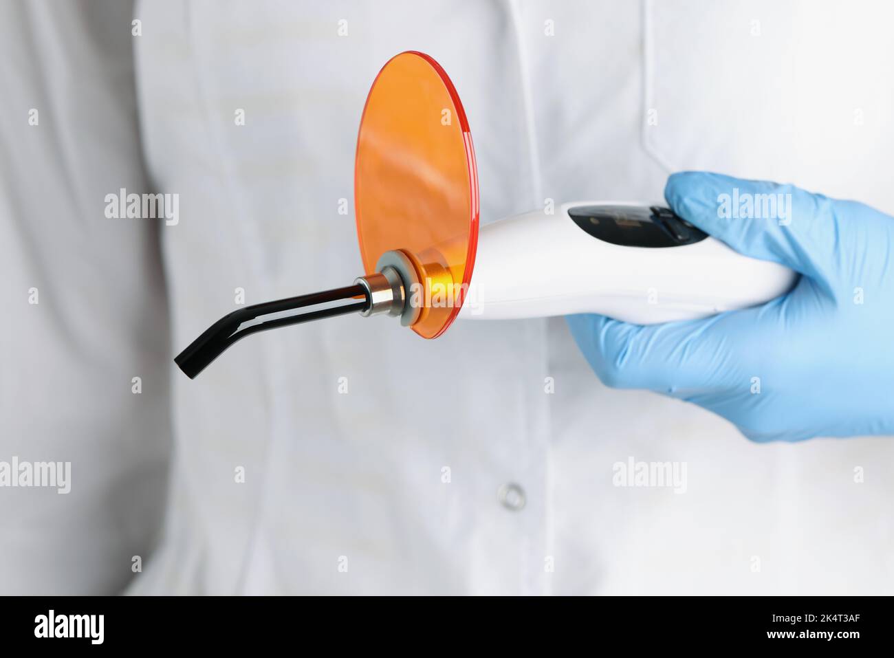 The doctor is holding dental led curing light, close-up Stock Photo - Alamy